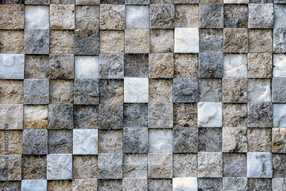 Wall made up of small square tiles arranged in a grid pattern. The ...