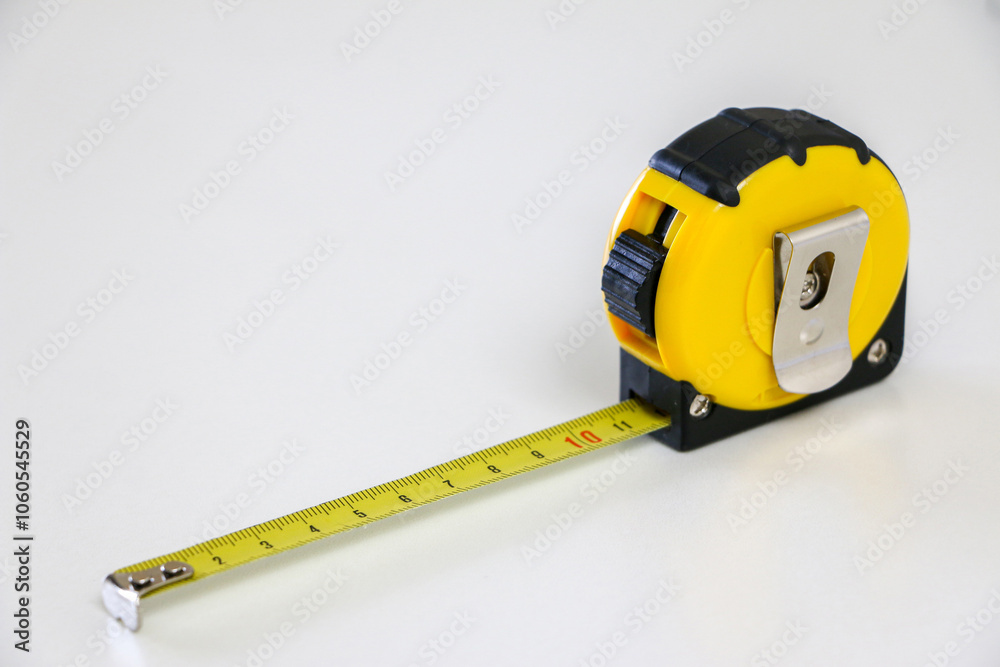 Black and yellow retractable tape measure held in place at 10 cm, on ...