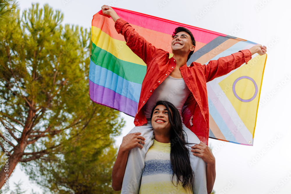 Happy non-binary couple celebrating lgbtq pride with LGBTQIA flag Stock ...