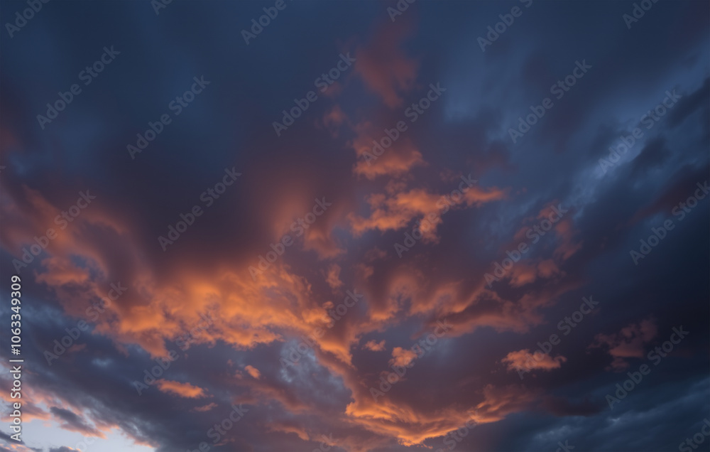 Clouds of deep indigo and amber, with a faint, golden light breaking ...