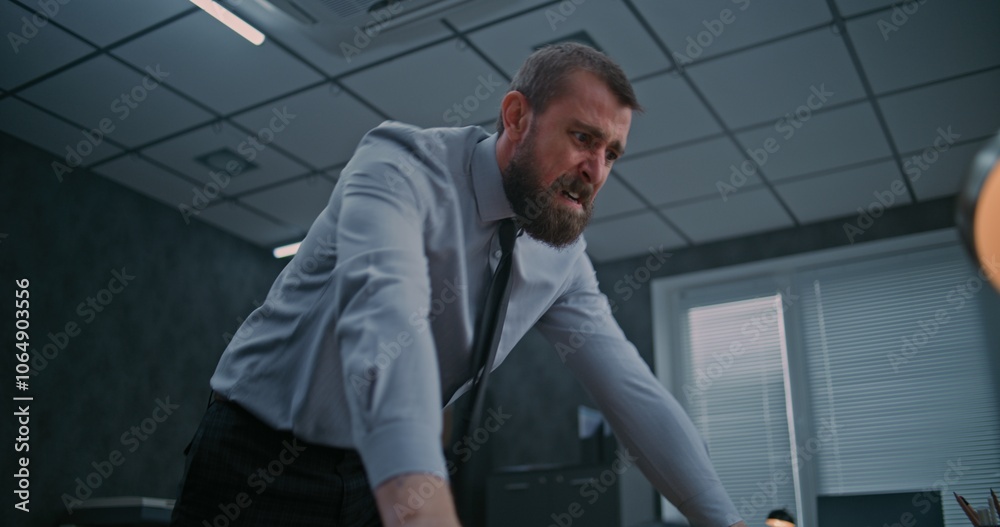 Aggressive businessman loses his temper in a fit of rage. Furious male ...