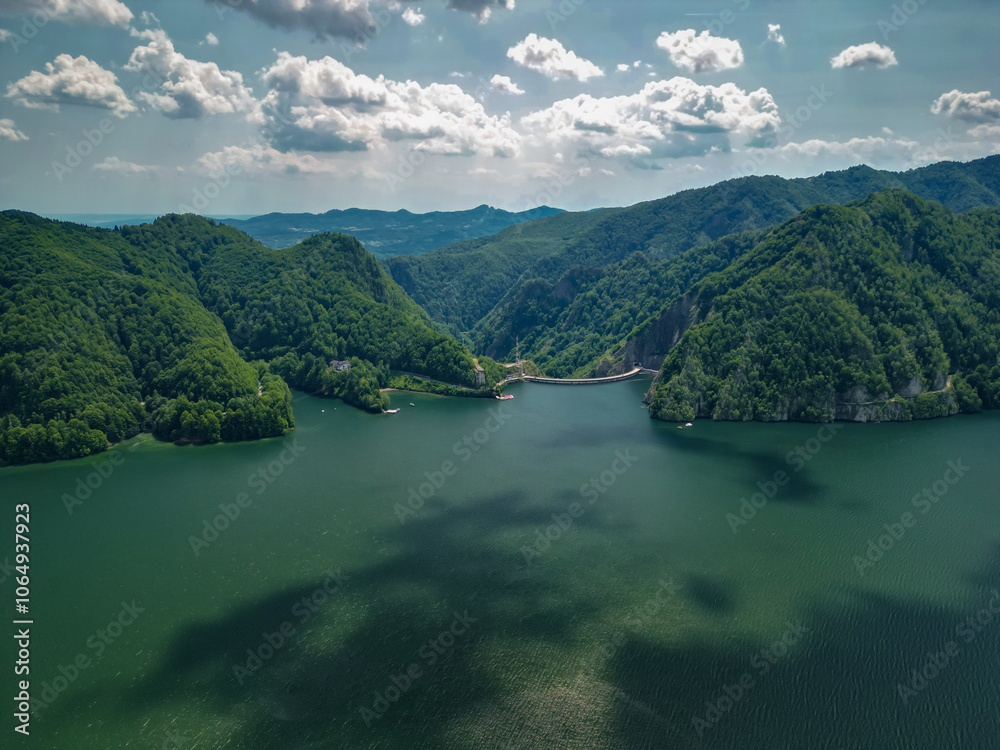 The Vidraru hydroelectric dam seen from the drone. Huge mountain lake ...