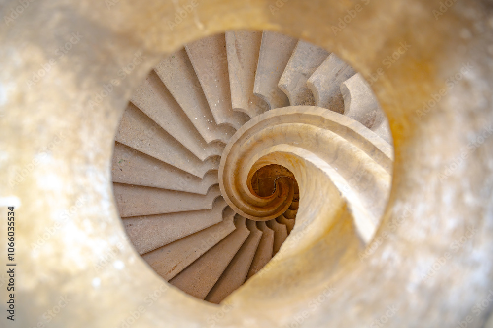 The helical staircase features smooth, curved steps that ascend ...