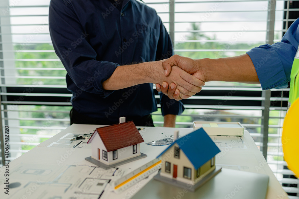 engineer and architect are shaking hands to celebrate because they just ...