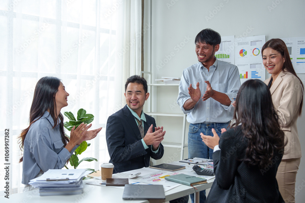 Team of cheerful Asian businessmen applauding their colleagues for ...