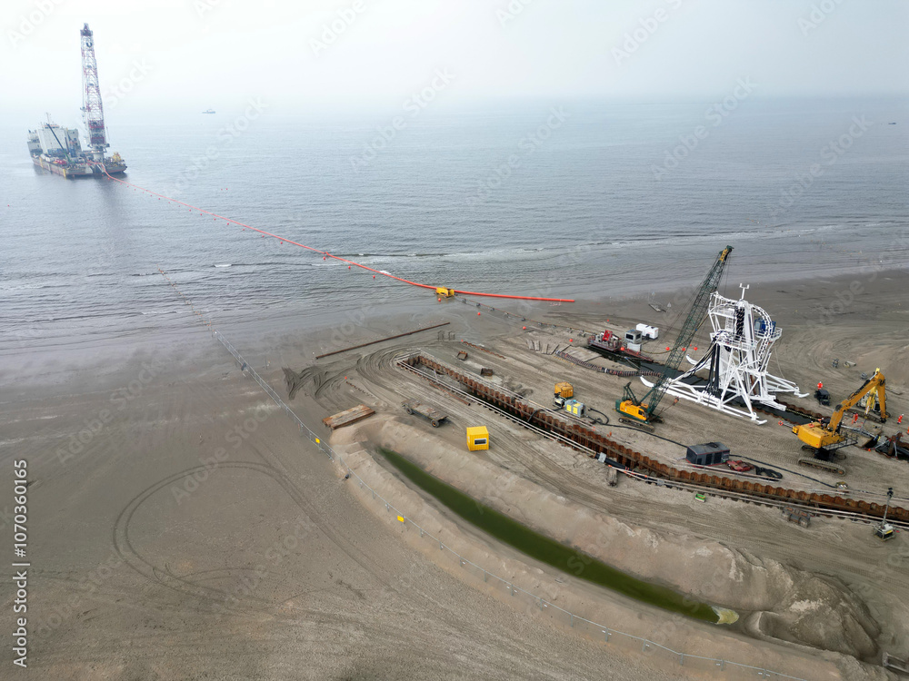 Connecting a seacable from an offshore windpark to an onshore power hub ...