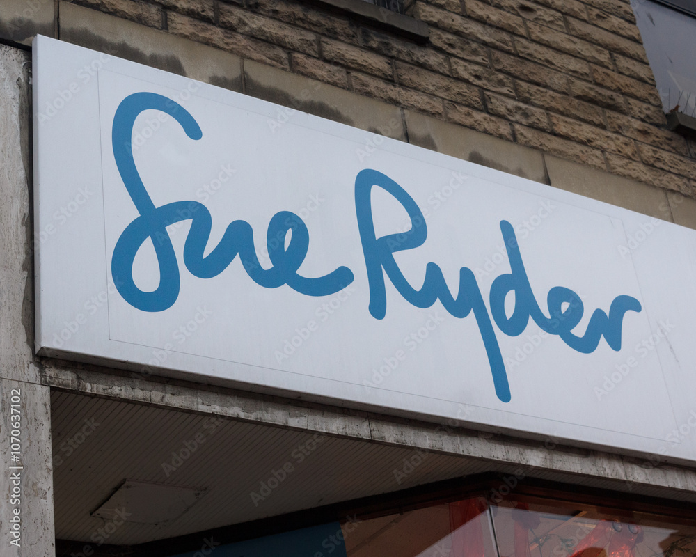 sign and logo of charity Sue Ryder who use charity shops to fund their ...