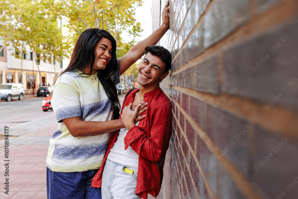 Latin transgender woman and her boyfriend laughing together in the city ...