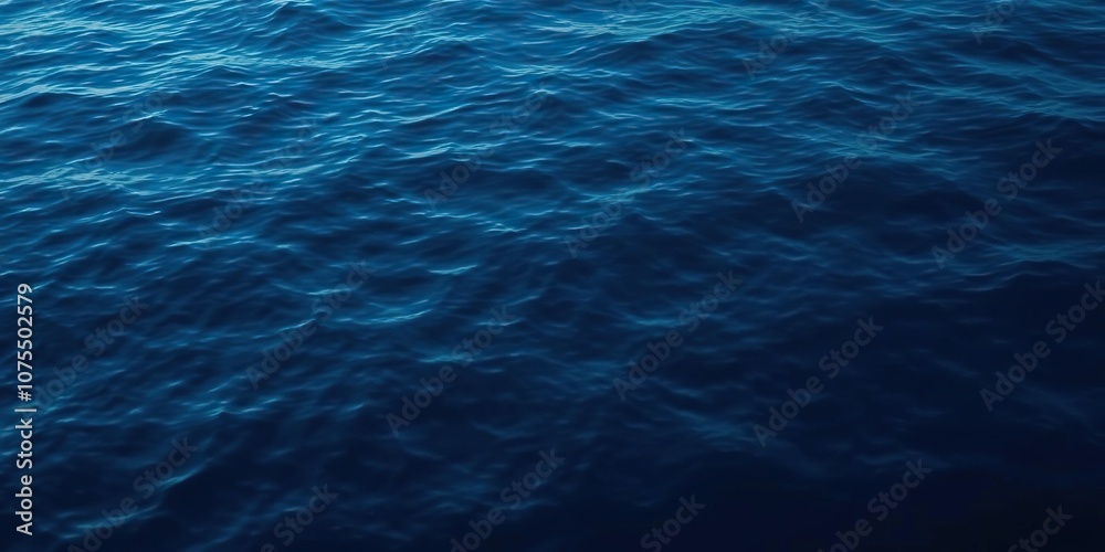 Dark blue abstract surface of the water with subtle rippling and ...