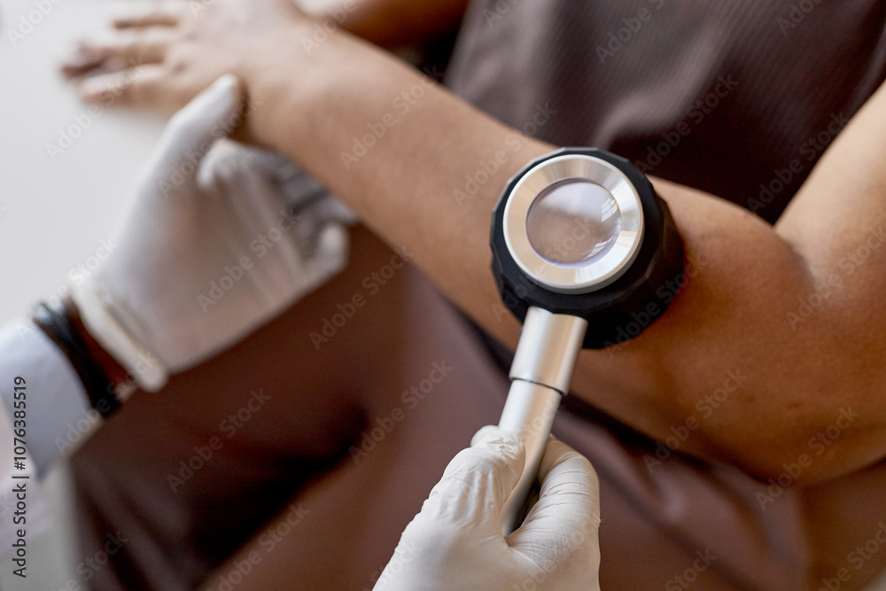 Close up of unrecognizable doctor holding dermatoscope while examining ...