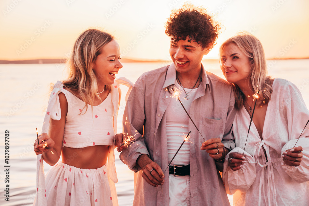 Young three smiling friends having fun during night party at the ...