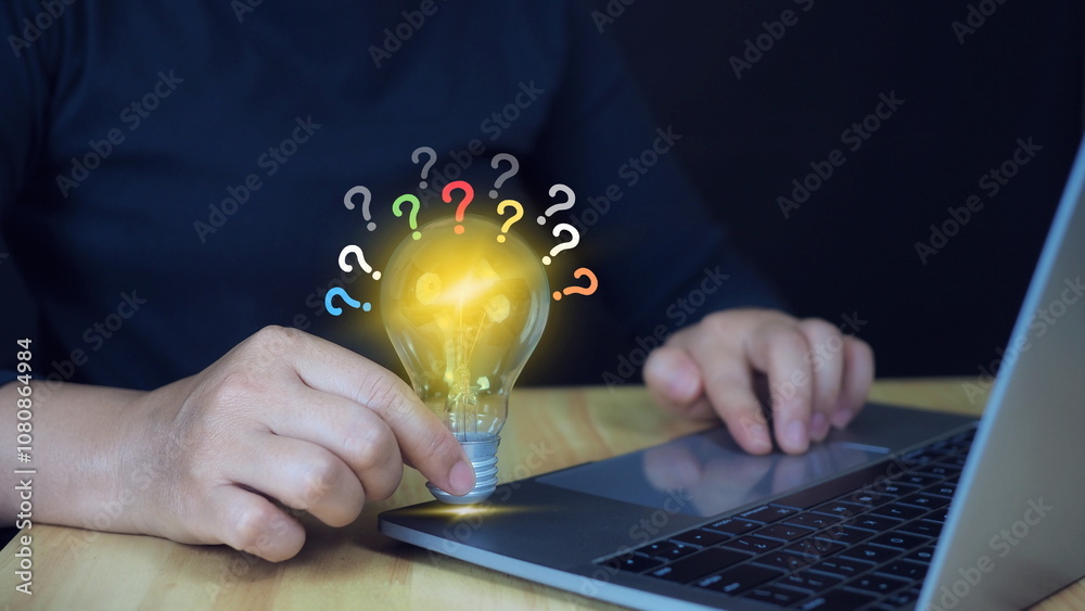 Businessman holding light bulb with question mark icon on virtual ...