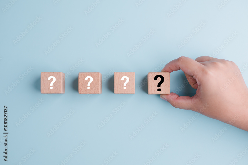 Wooden cube block in question mark mean what on cement table background ...