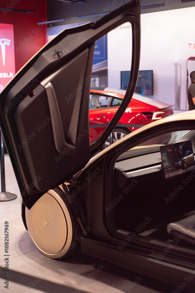 Butterfly doors open on Tesla CyberCab Robotaxi at showroom with large ...