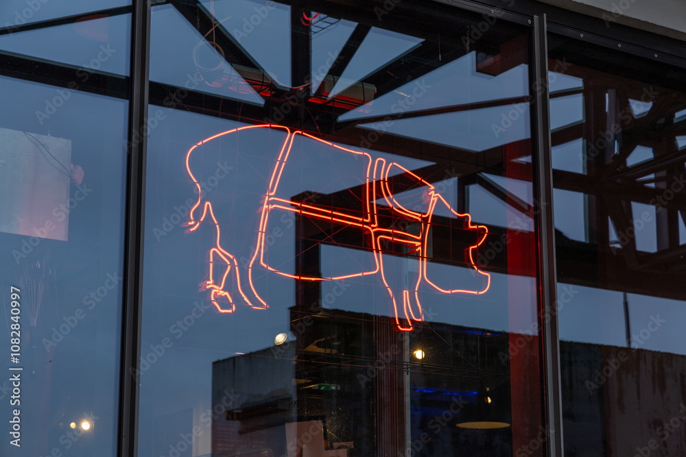 Cuts of Pork, a Pig Diagram in neon outline drawing behind a butcher's ...