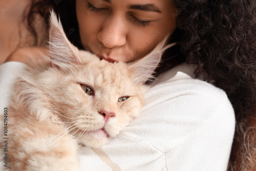 Beautiful young happy African-American woman kissing her cute Maine ...