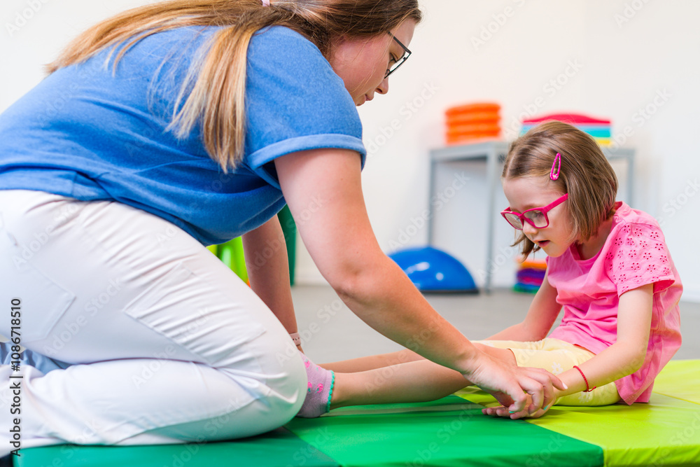 Child with physical disability in physical therapy session. Child living with cerebral palsy ...