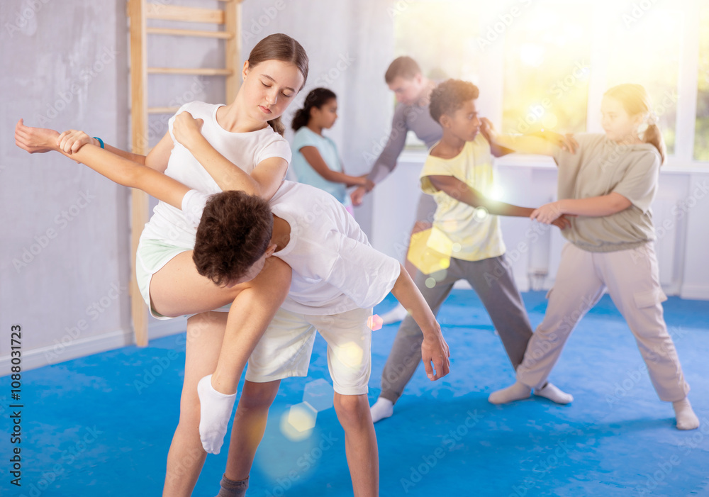 Multinational group of schoolchildren taking self-defense classes at ...