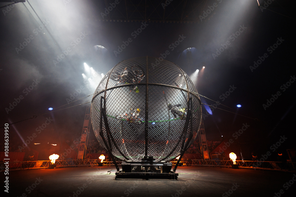 Dangerous show involving motorcyclists in circus. Stuntmen ride ...