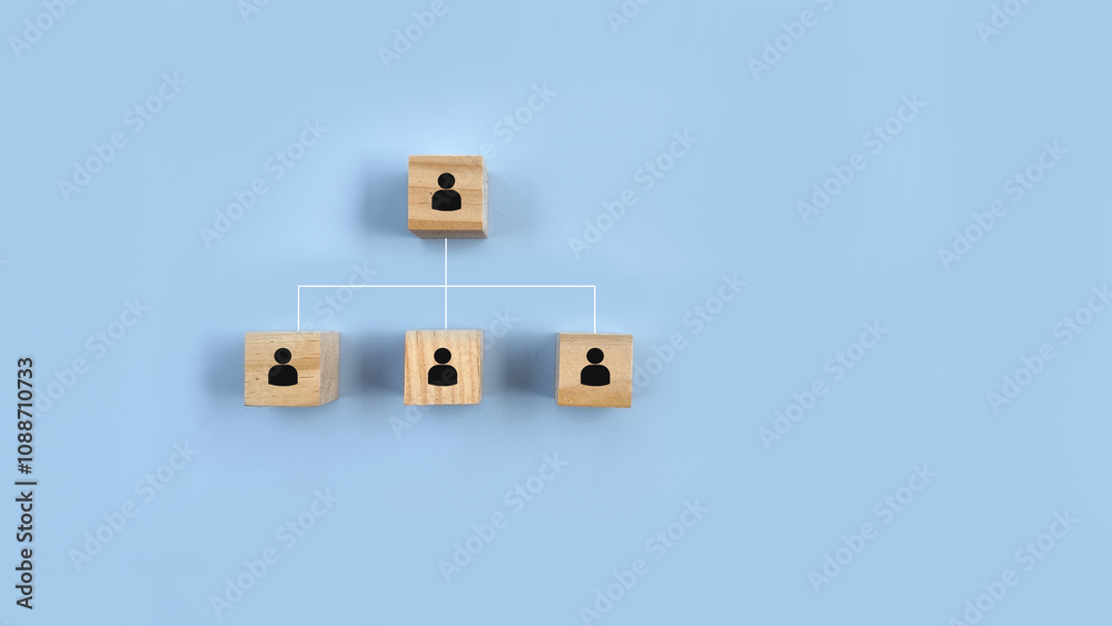 Organisation chart, mind map. Wooden blocks with people icons on blue ...