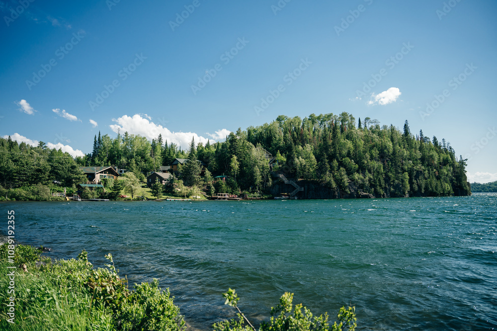 Imagery with small lakes, forest and beautiful blue sky with big puffy ...