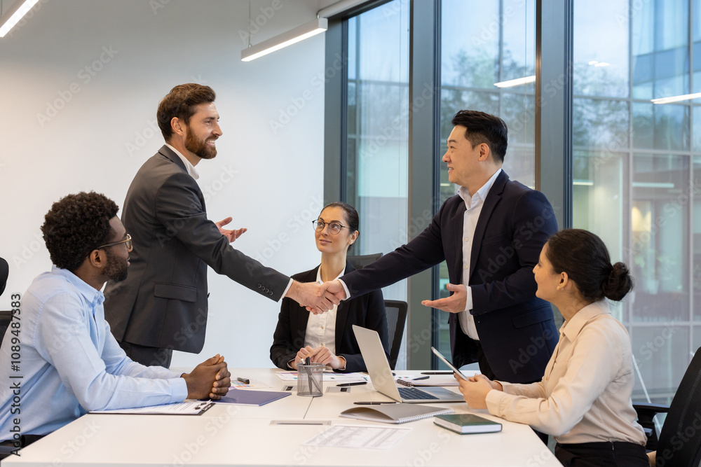 Business professionals engaged in meeting room. Two colleagues in ...