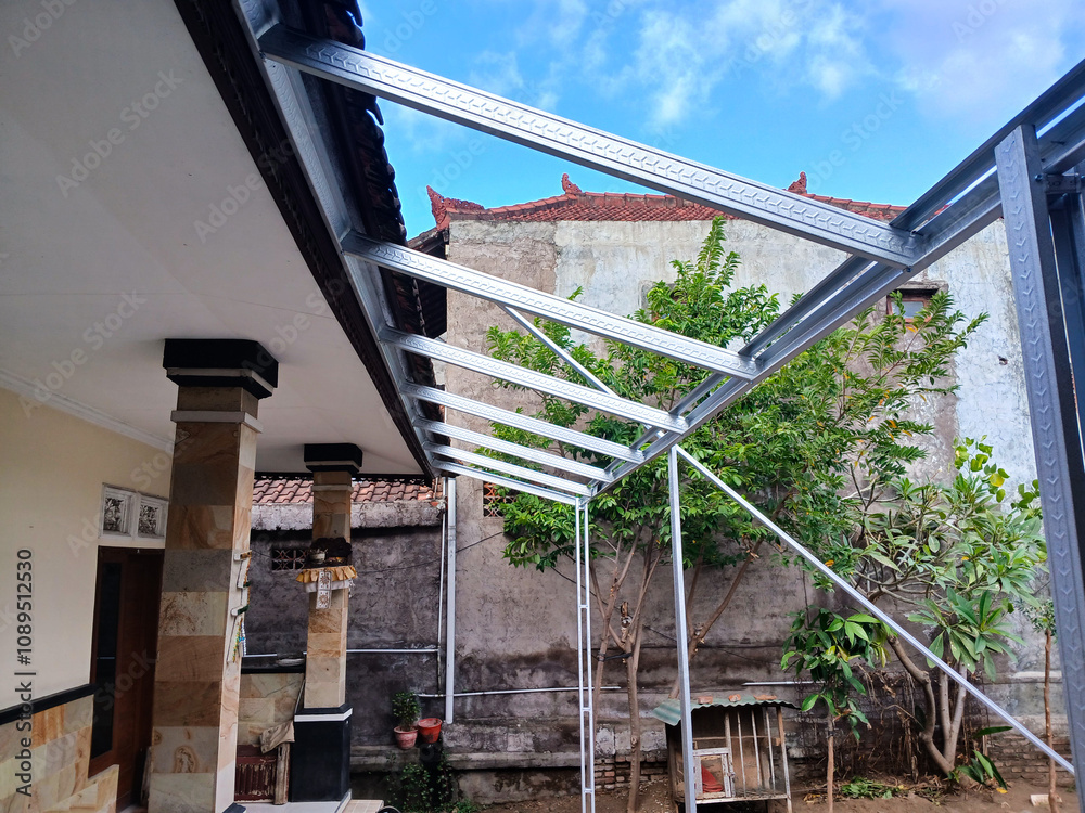 Construction of a lightweight steel canopy frame attached to a house ...