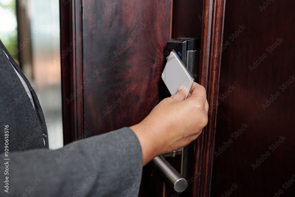 Hand holding key card and using it for security access control on ...