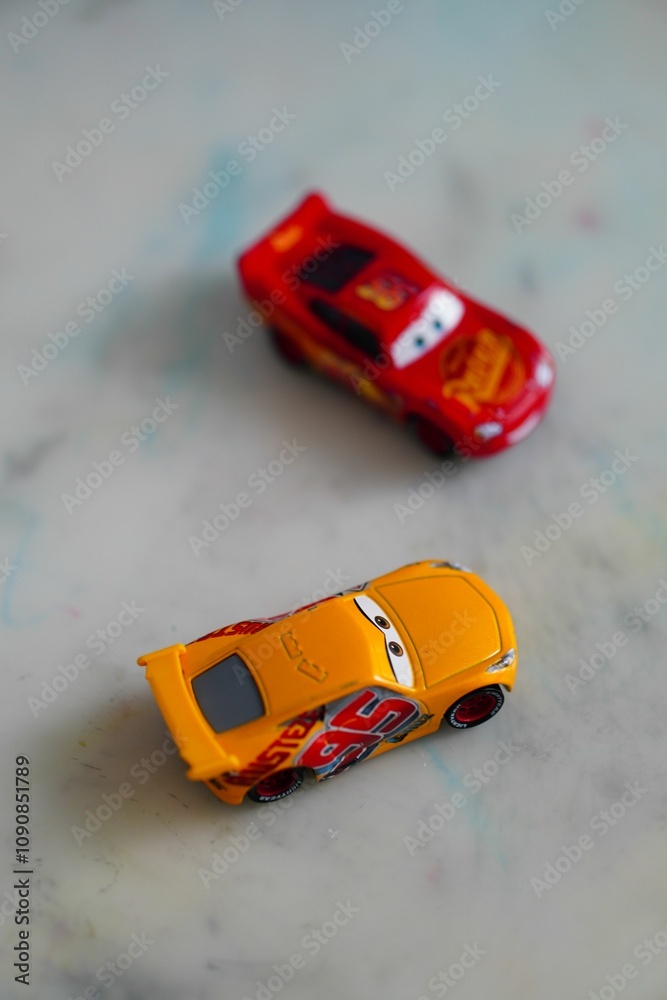 Vertical shot of Mattel Cruz Ramirez and Lightning McQueen toy model ...