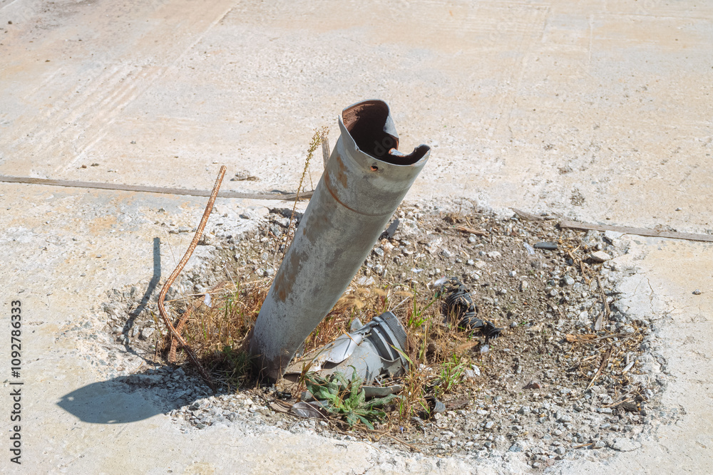 Incoming and exploding MLRS projectile in road with concrete surface ...