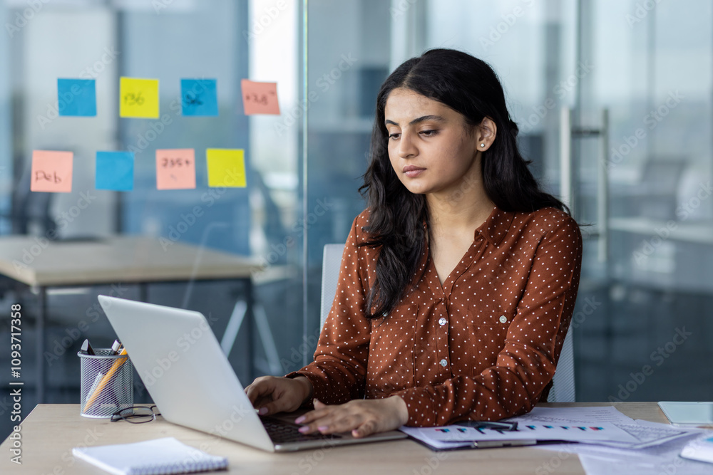 Latin American woman businesswoman working on laptop in office with ...