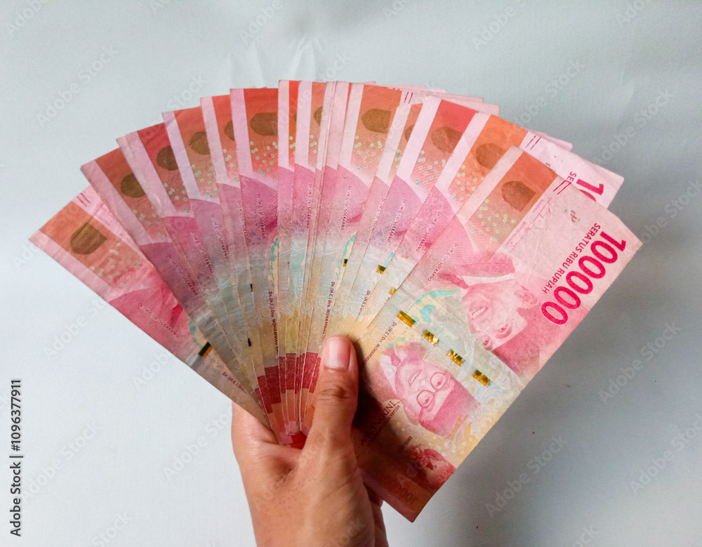 Cash payment concept. Indonesian rupiah currency (Rp. 100.000 Seratus ...