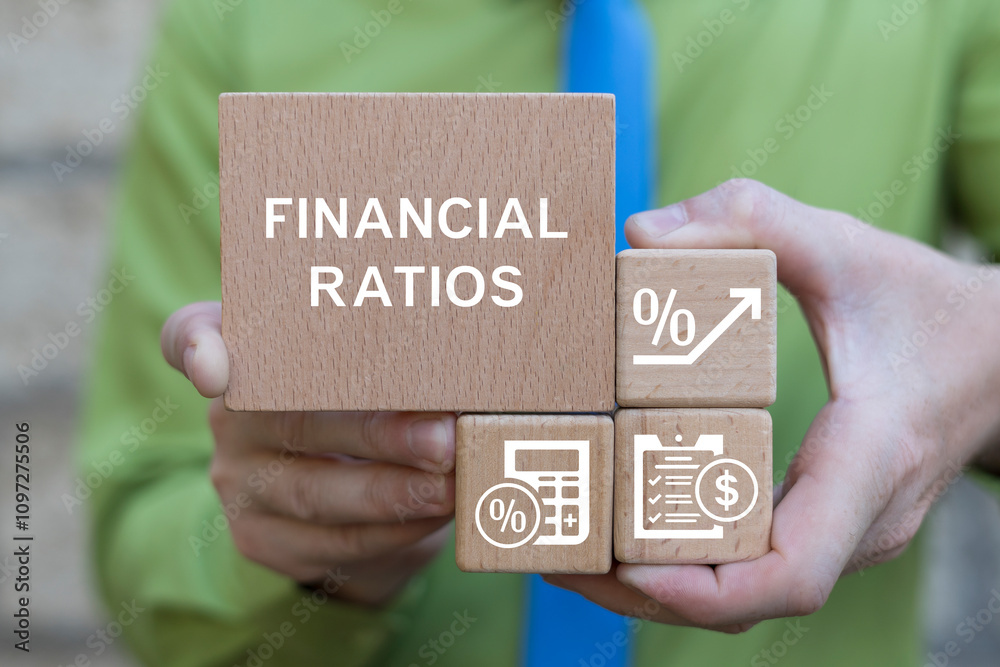 Business man holding wooden blocks sees text: FINANCIAL RATIOS ...
