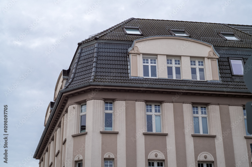 Building with mansard roof and dormer windows showing classical ...