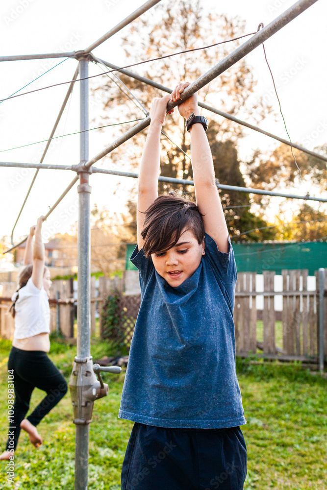 First Nations Australian kids swinging on hills hoist rotary ...