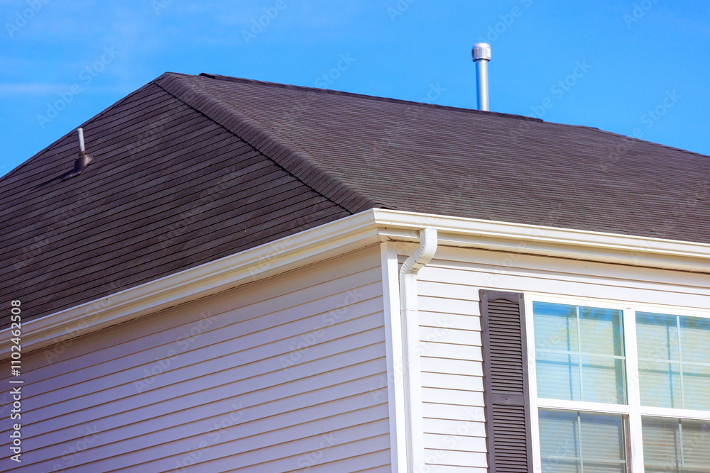 Well maintained residential roof featuring asphalt shingles, white ...