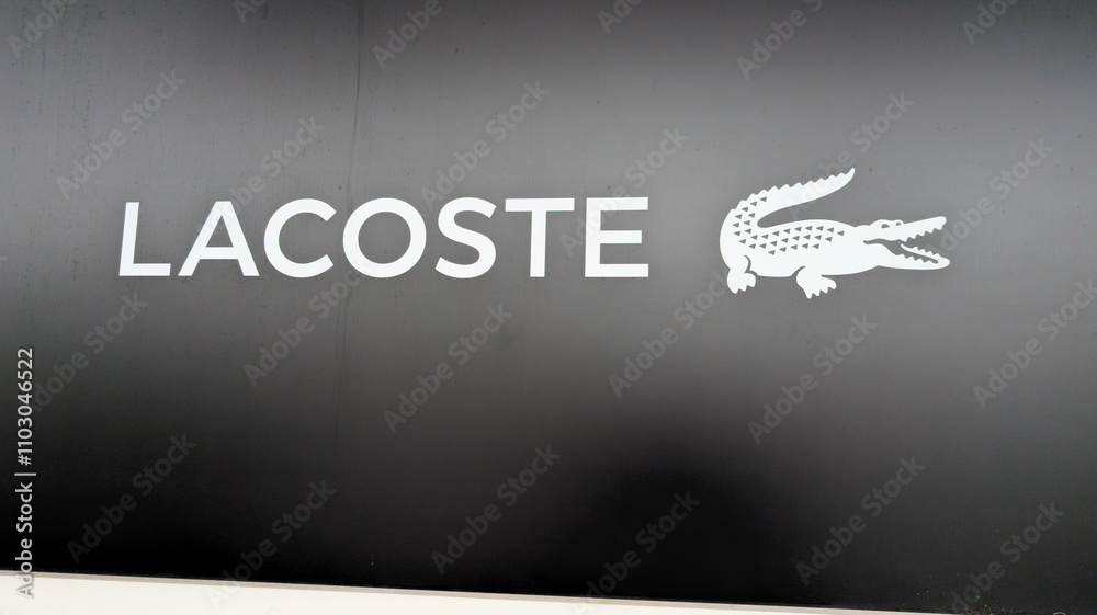 Lacoste text brand and crocodile logo closeup of shop chain sign on ...