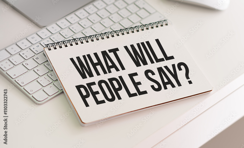 What Will People Say writing on a notepad with keyboard and a pen on a ...