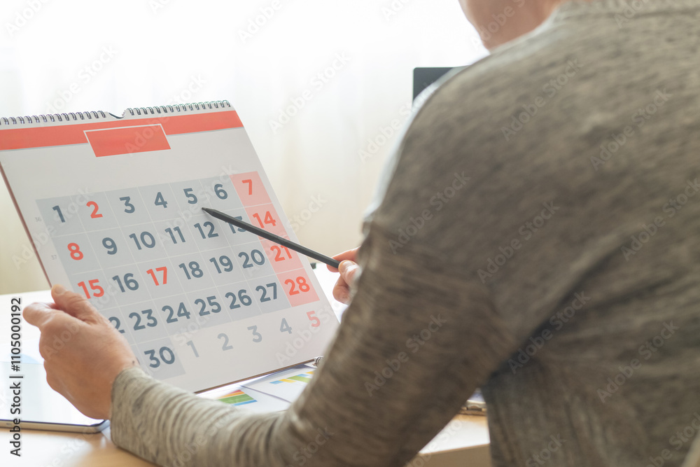 Strategic Planning with Calendar, Person Consulting Dates to Organize ...