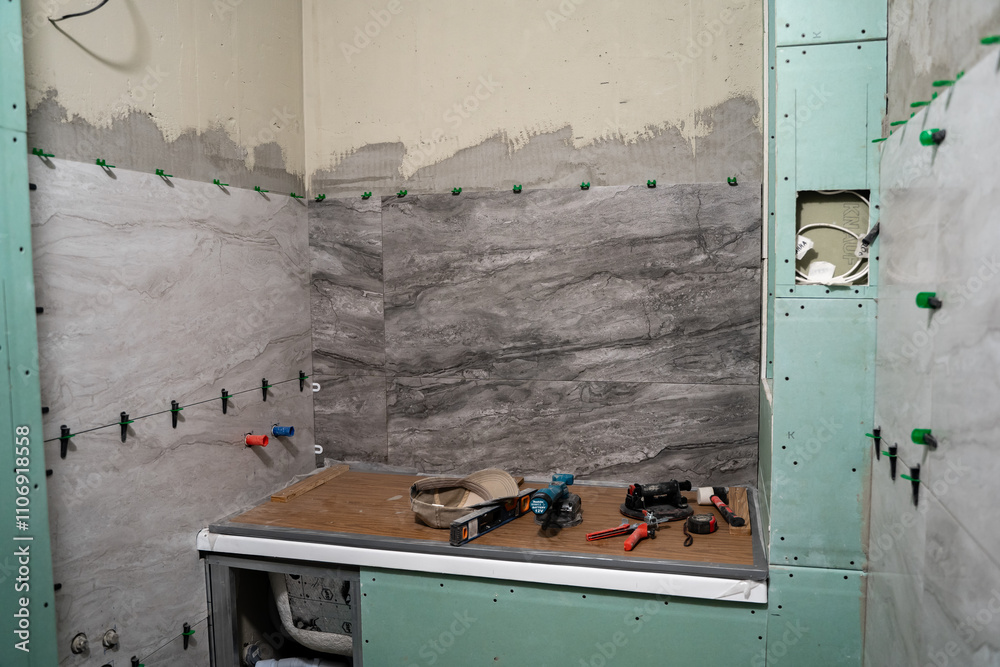 Bathroom renovation, wall markings for laying tiles, construction work ...