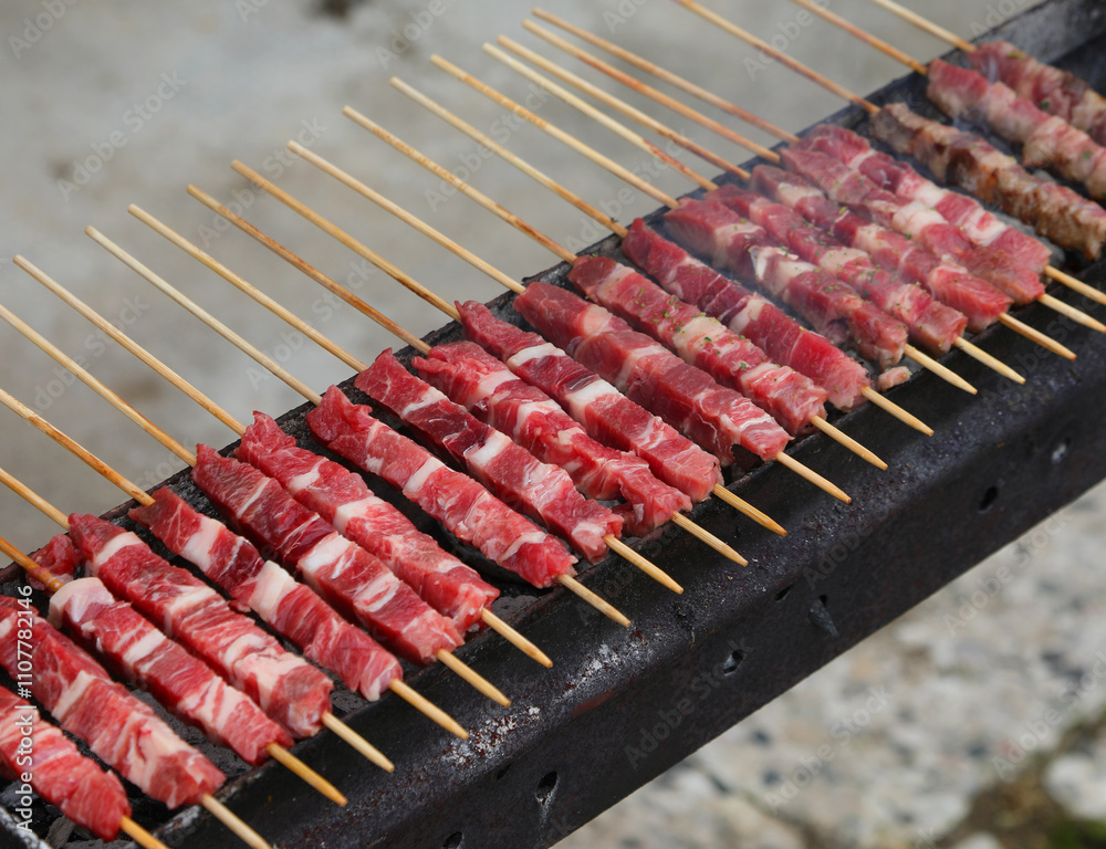 skewers of raw sheep and ram meat called ARROSTICINI grilled over coals ...
