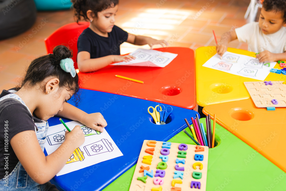 Three children coloring in the classroom during back-to-school season ...