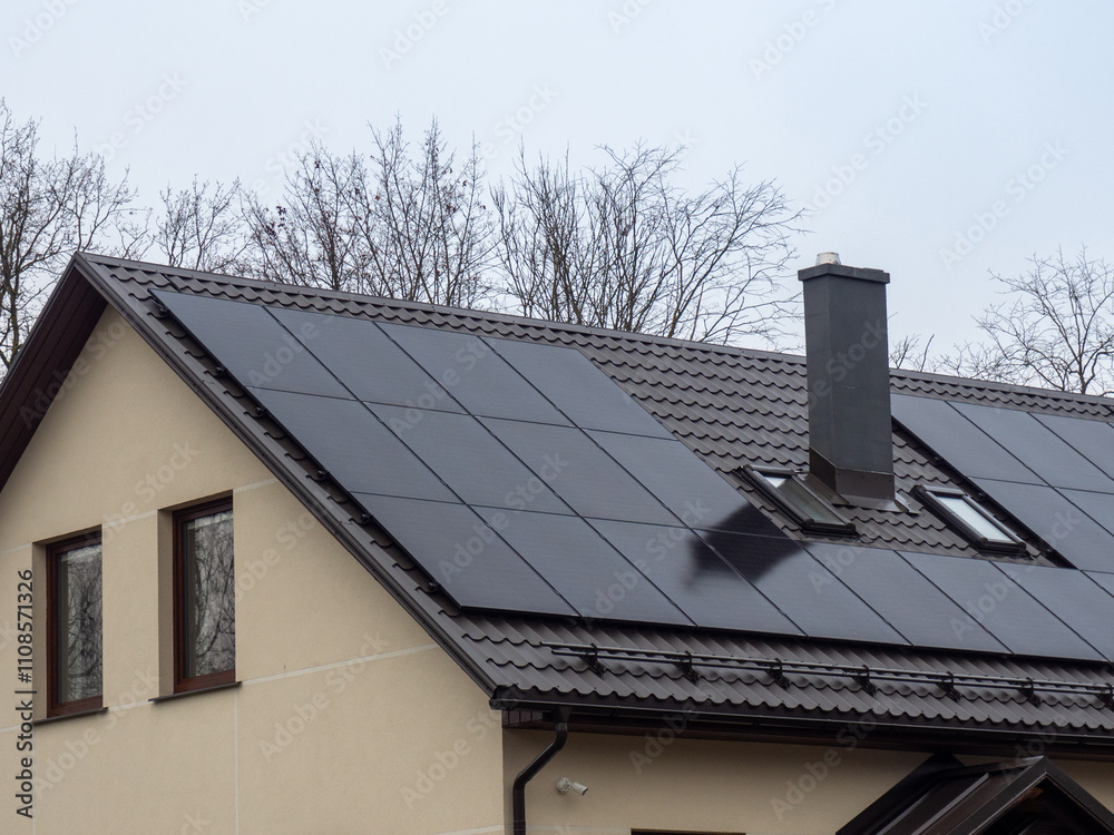Black solar panels on the roof of the house. Solar energy solutions for ...