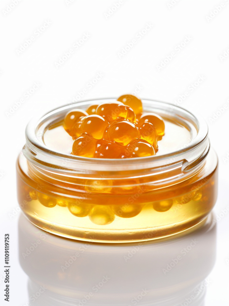 One single golden trout roe caviar pearl, perfectly round, smooth ...