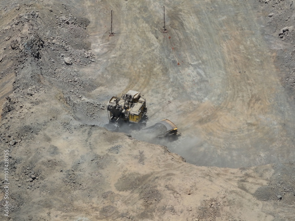 Electric Mining Shovel in Full Operation Loading Trucks at an Open-Pit ...