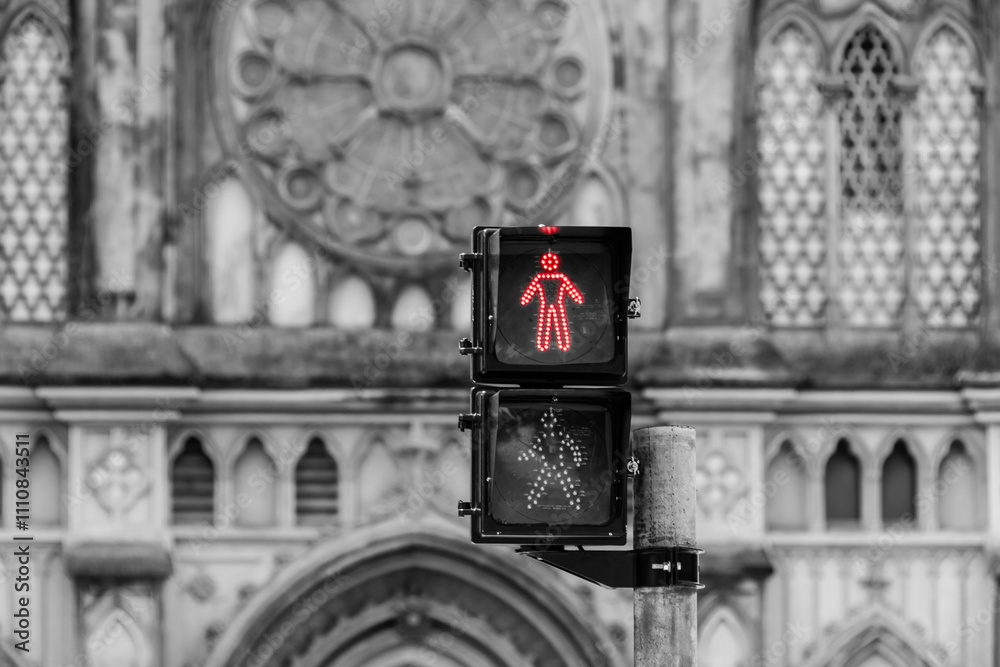 Pedestrian traffic light signaling red. In the background, construction ...