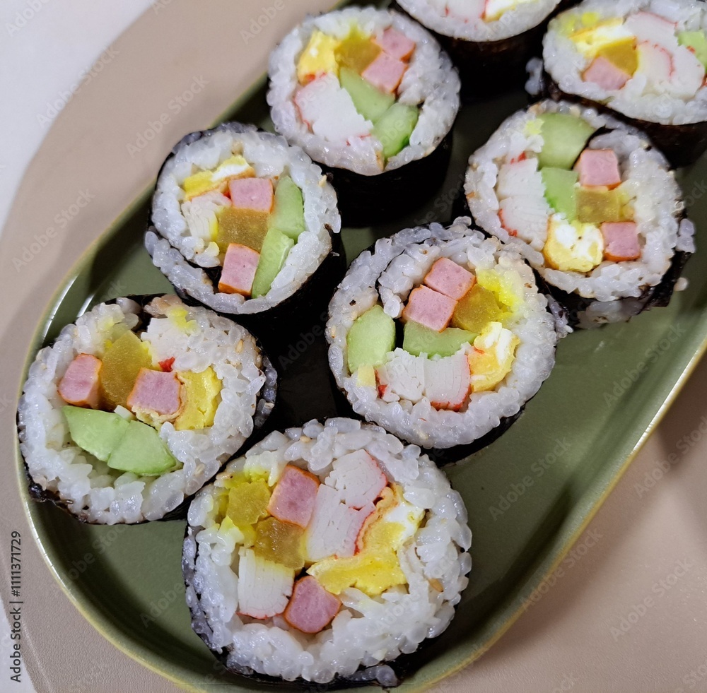 Delicious kimbap rolls filled with fresh vegetables, seasoned rice, and ...