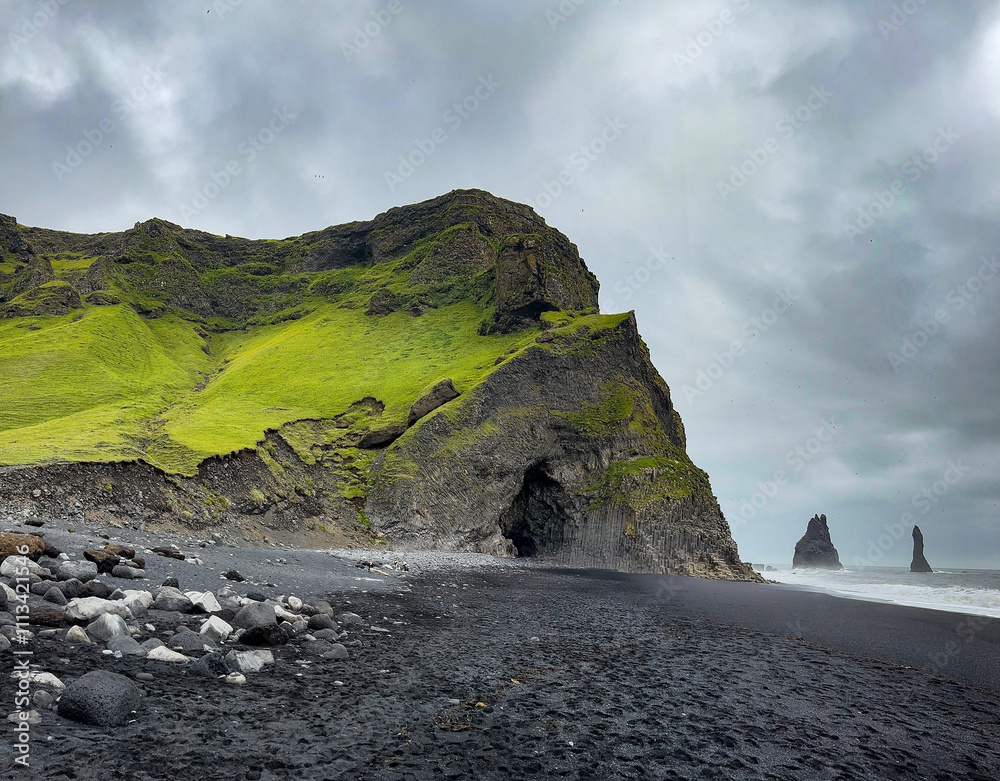 Reynisfjara black-sand beach features a cave, basalt columns and the ...