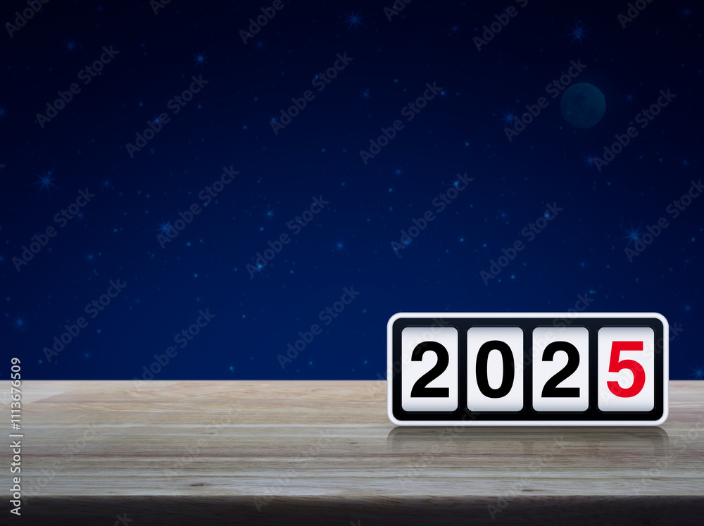 Retro flip clock with 2025 text on wooden table over fantasy night sky and moon, Happy new year ...