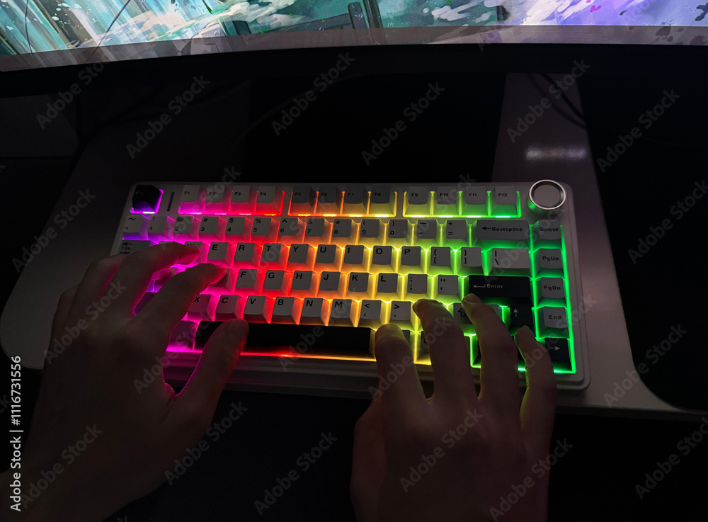 White gaming keyboard on black background, hands and multi-colored ...